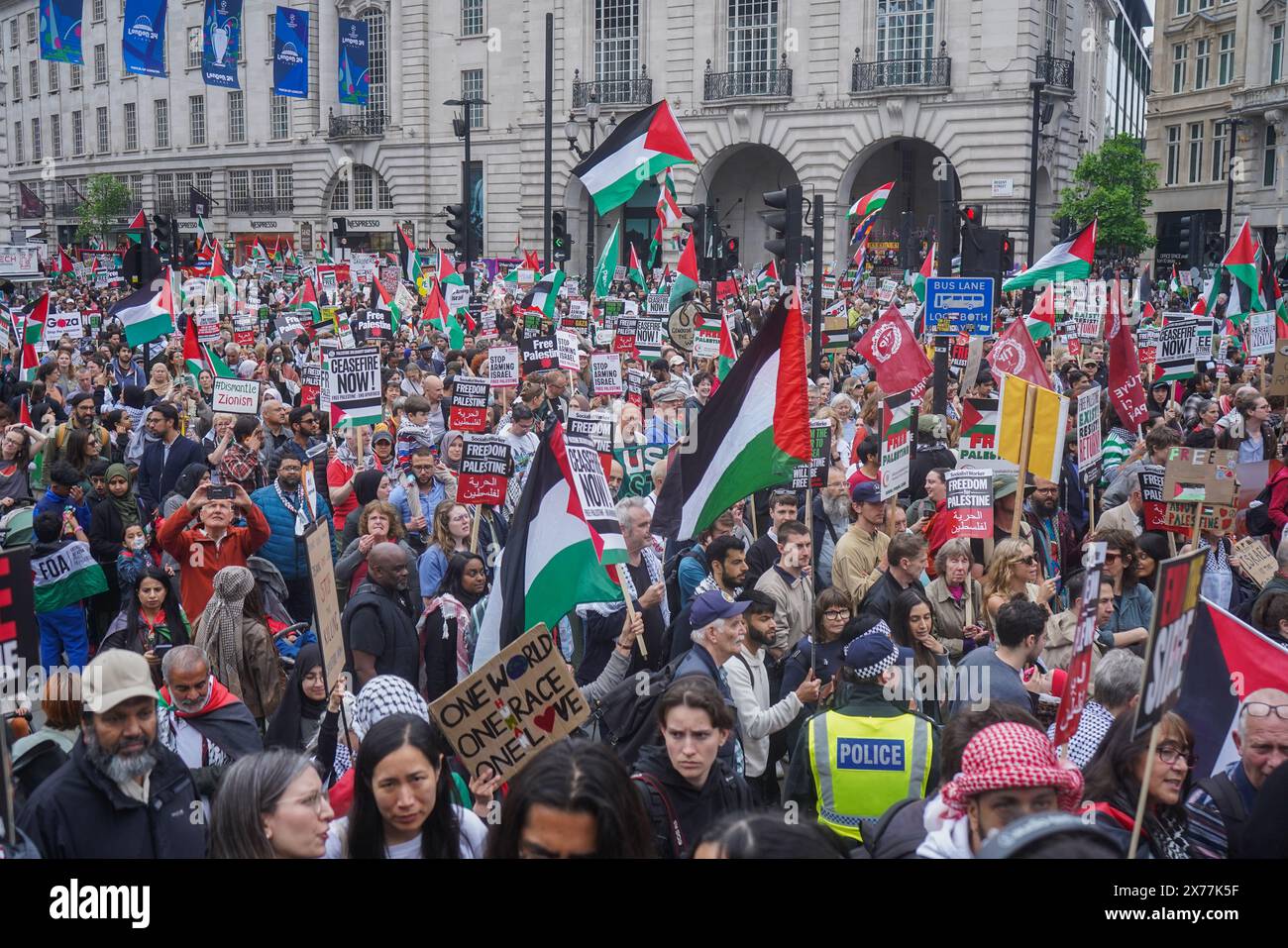 London, UK. 18 May, 2024. A Pro Palestinian supporter carries a large ...