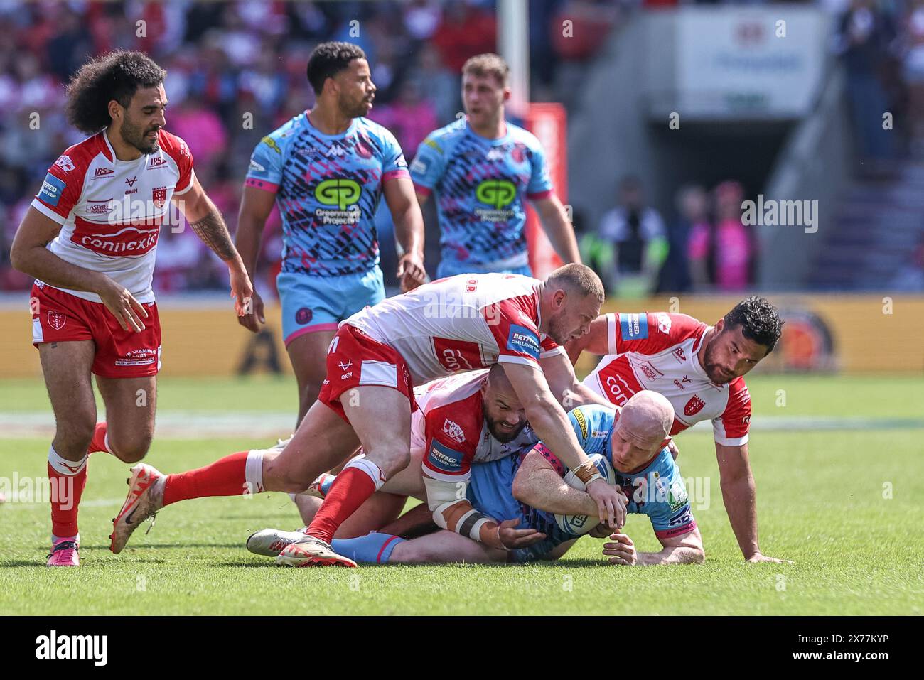 Liam Farrell of Wigan Warriors is tackled by George King of Hull KR ...