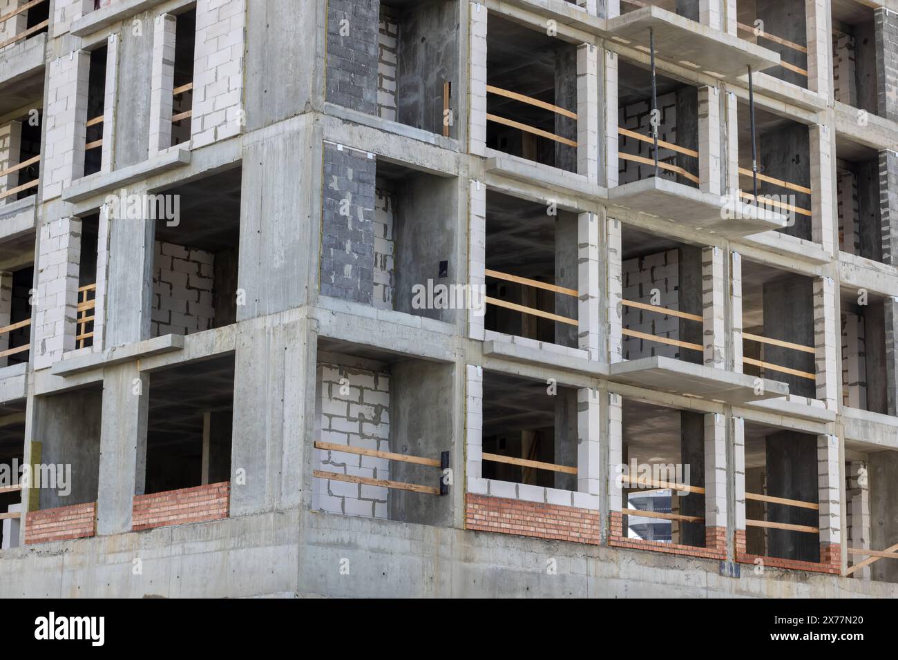A tower block under construction, featuring a facade with numerous ...