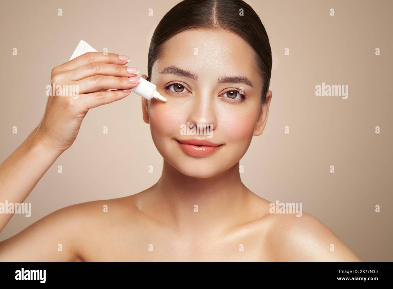 Beautiful woman using cream around the eyes. Video of woman with ...