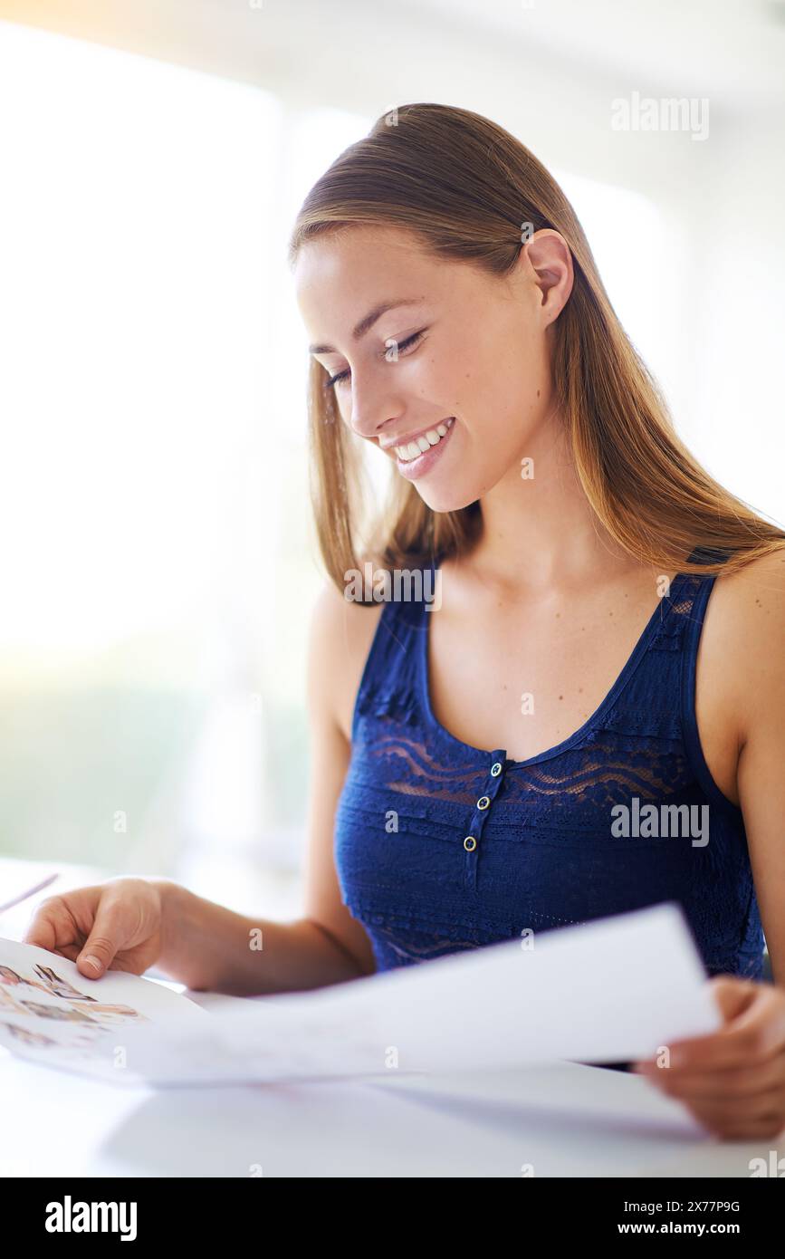 Woman, home and happy with page on table, magazine editor and catalog ...