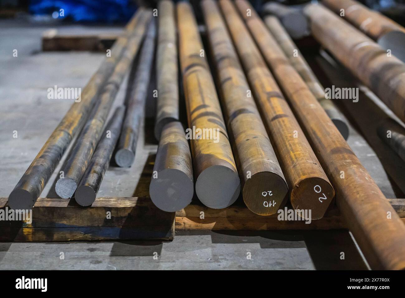 Round long metal billets at a steel mill Stock Photo - Alamy