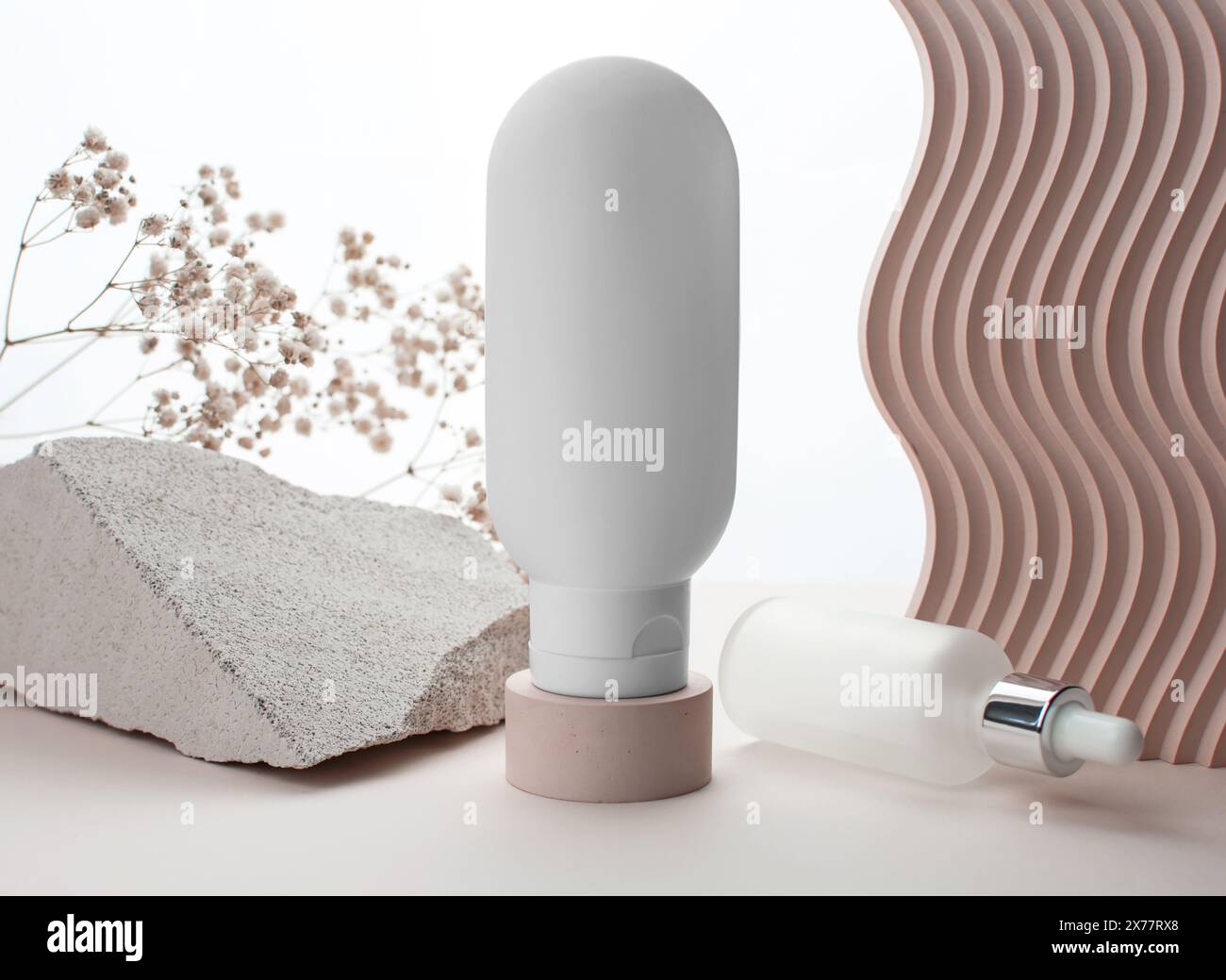 Empty white plastic tube on a round plaster podium. Natural cosmetics ...