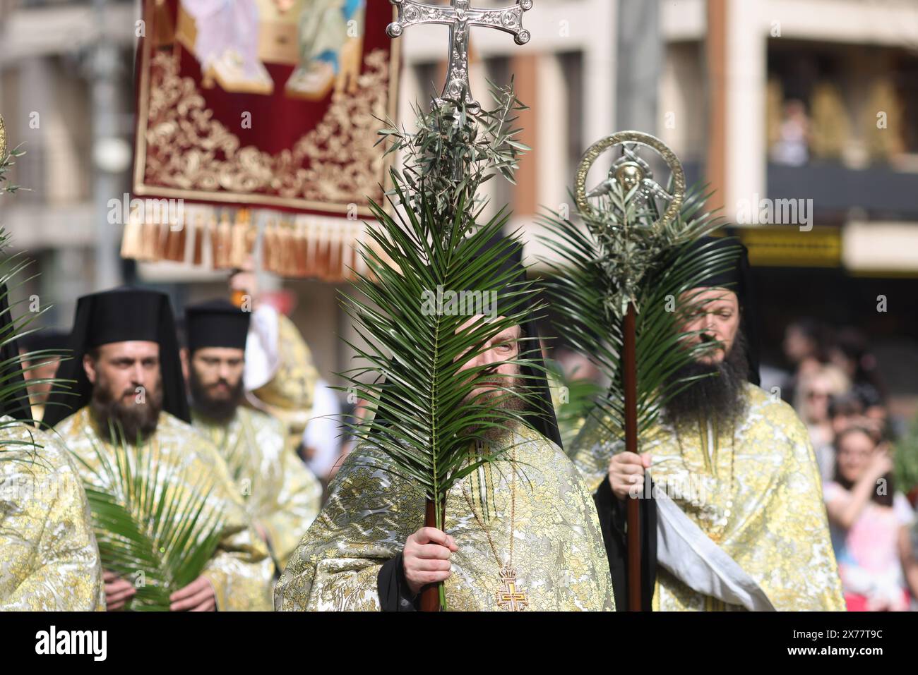 Romanian Orthodox priests holding palm leaves walk on the streets of ...