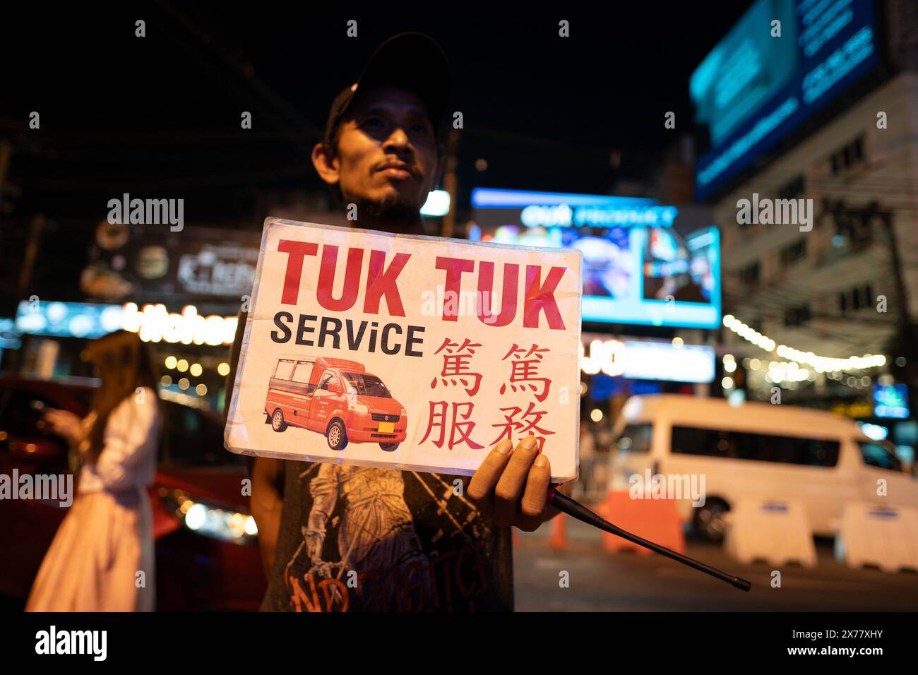 PHUKET, THAILAND - APRIL 15, 2023: a man hold tuk tuk service sign at ...