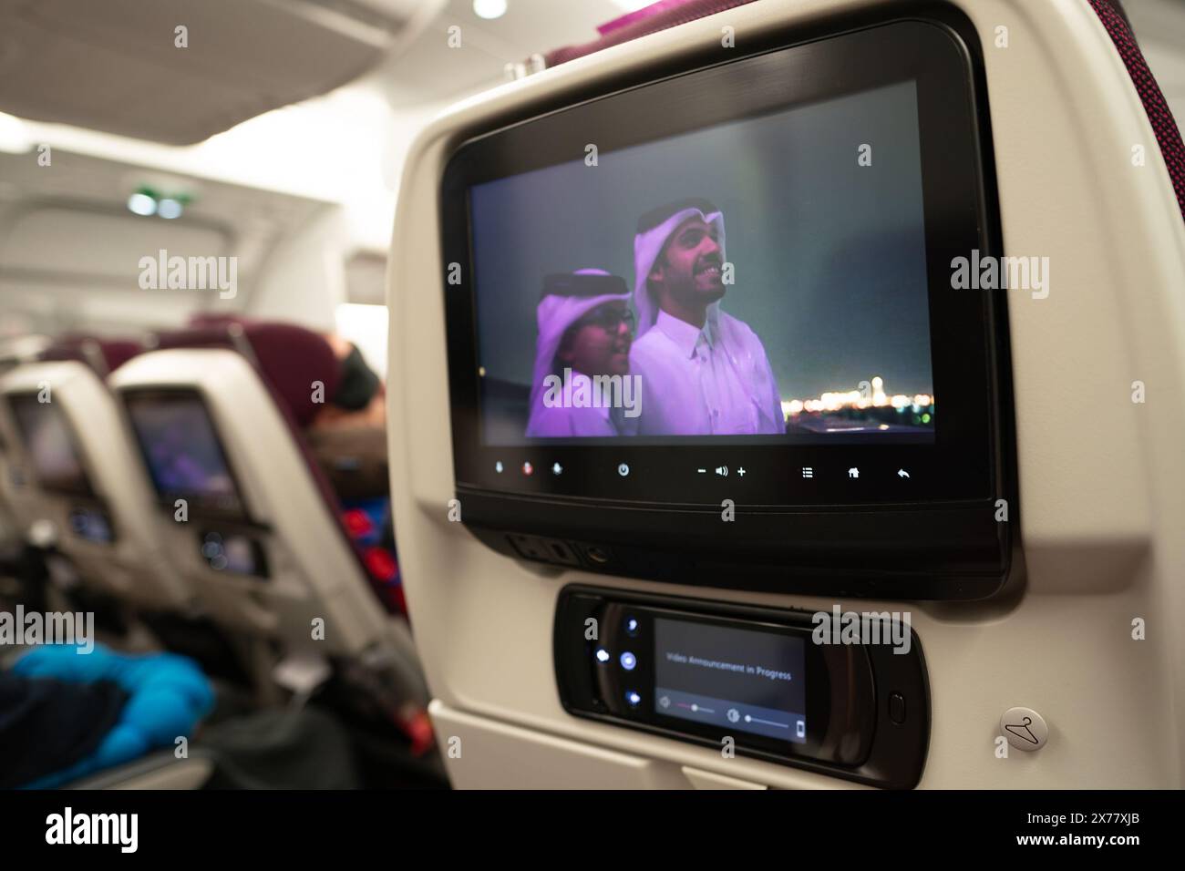 DOHA, QATAR - DECEMBER 15, 2023: a Qatar Airways economy class seat equipped with in-flight ...