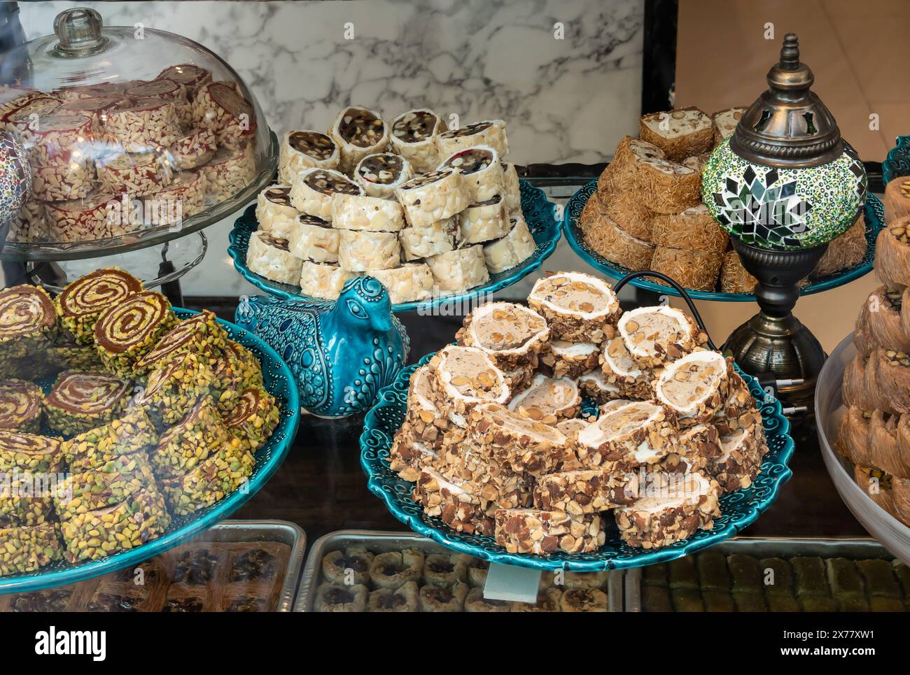 Turkish sweets in a bake shop window. Looking through the glass at blue ...