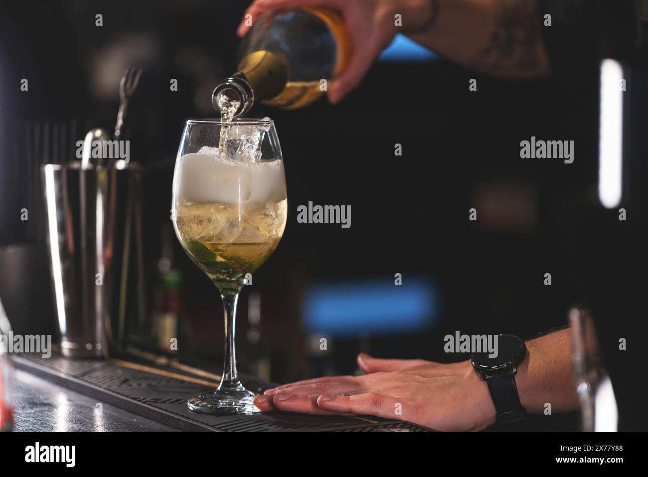 Bartender pouring cocktail into ice filled glass Stock Photo - Alamy