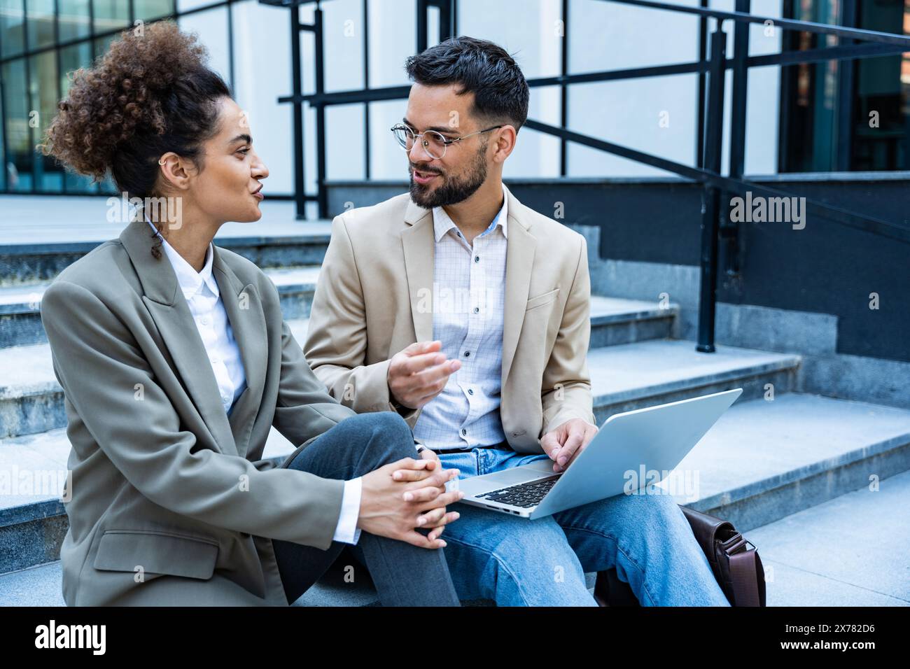 Successful business people working, talking together in urban ...