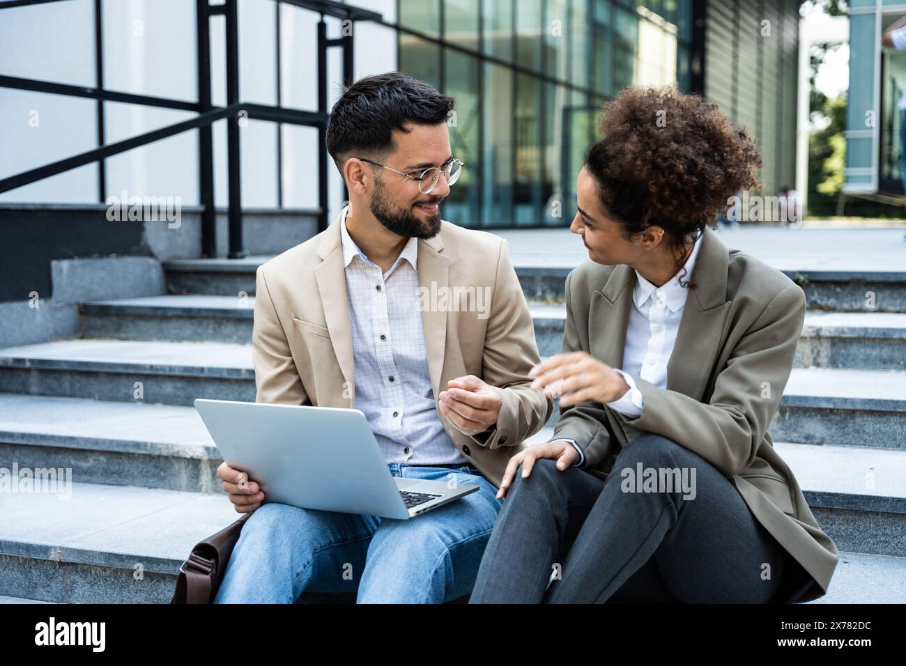 Successful business people working, talking together in urban ...