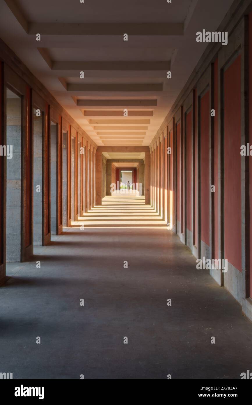 The hallway is spacious and grand, adorned with striking red walls and ...