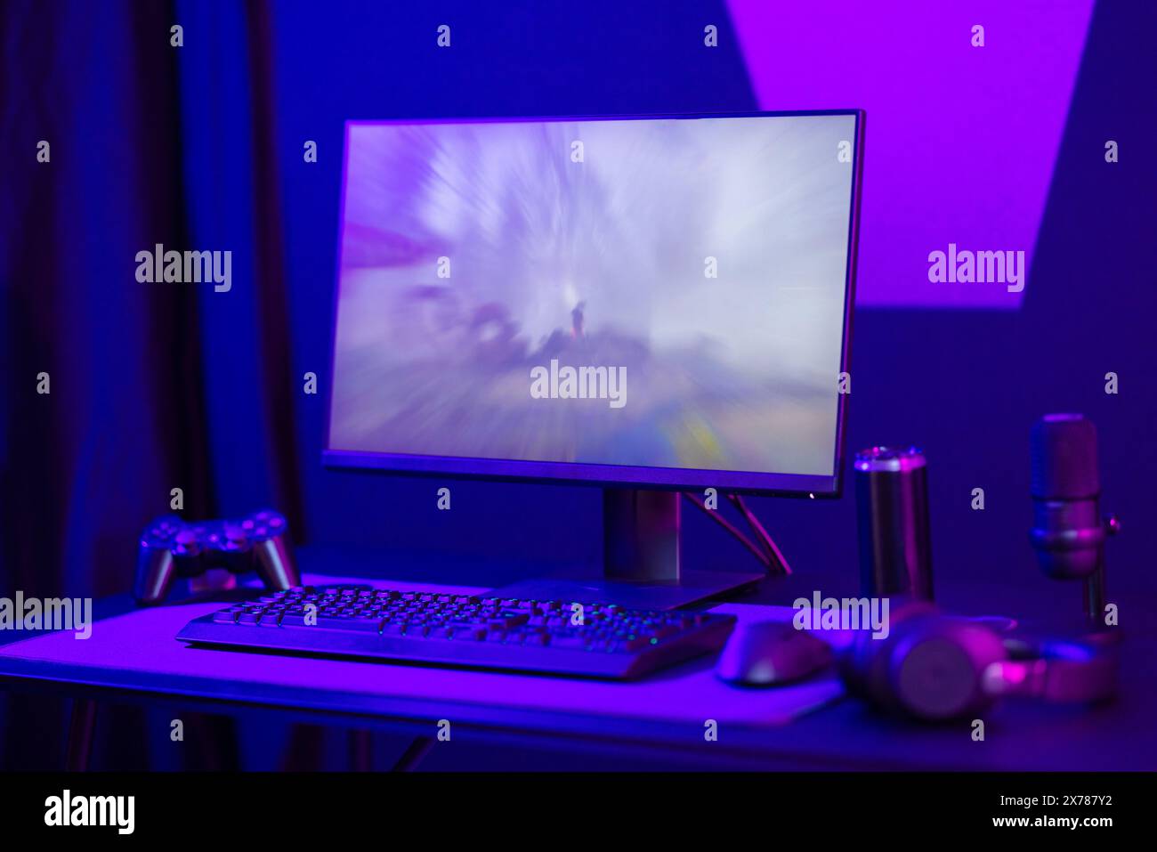 Modern gaming setup with controller, keyboard, and mic in purple ...