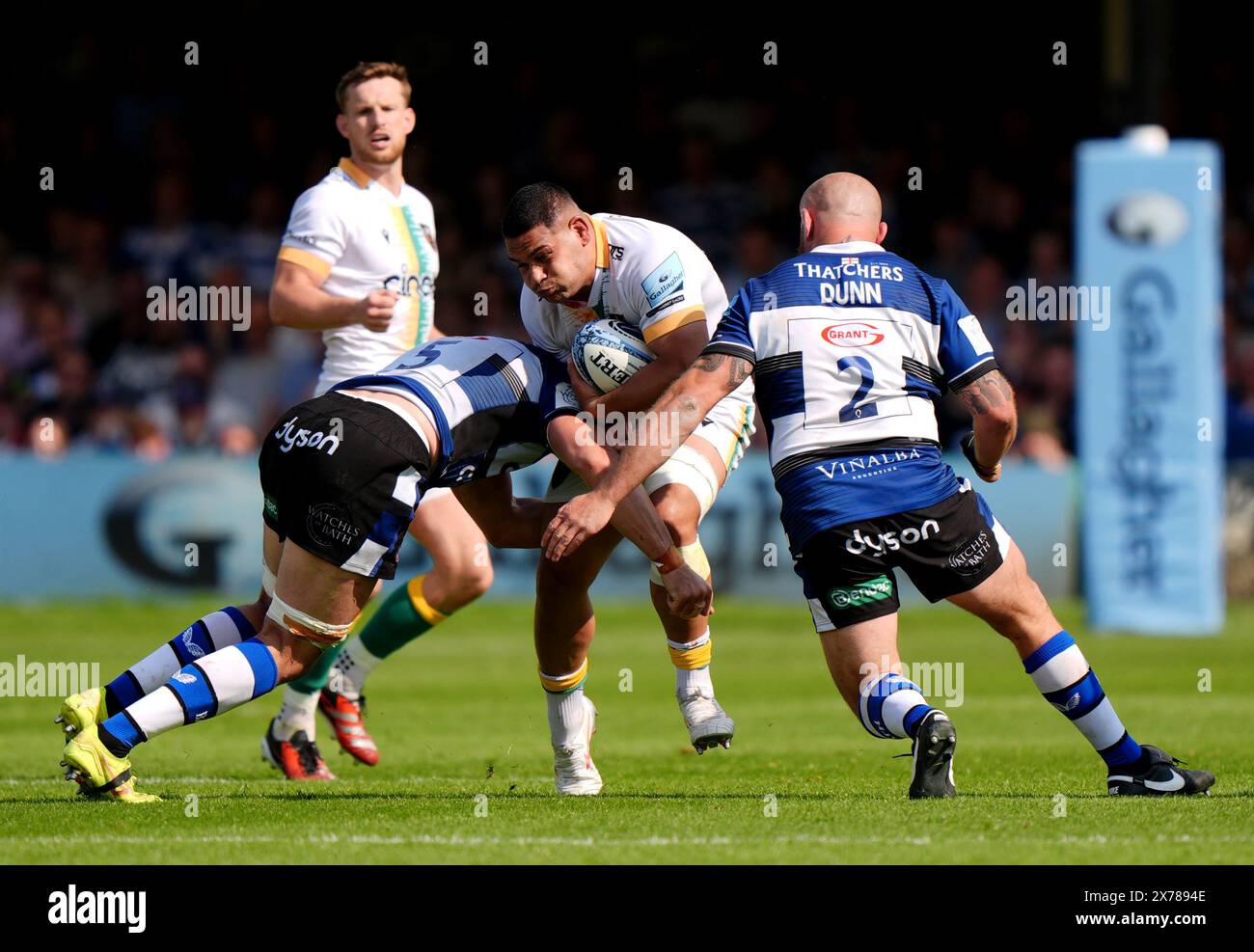 Northampton Saints' Sam Matevesi is tackled by Bath's Charlie Ewels ...
