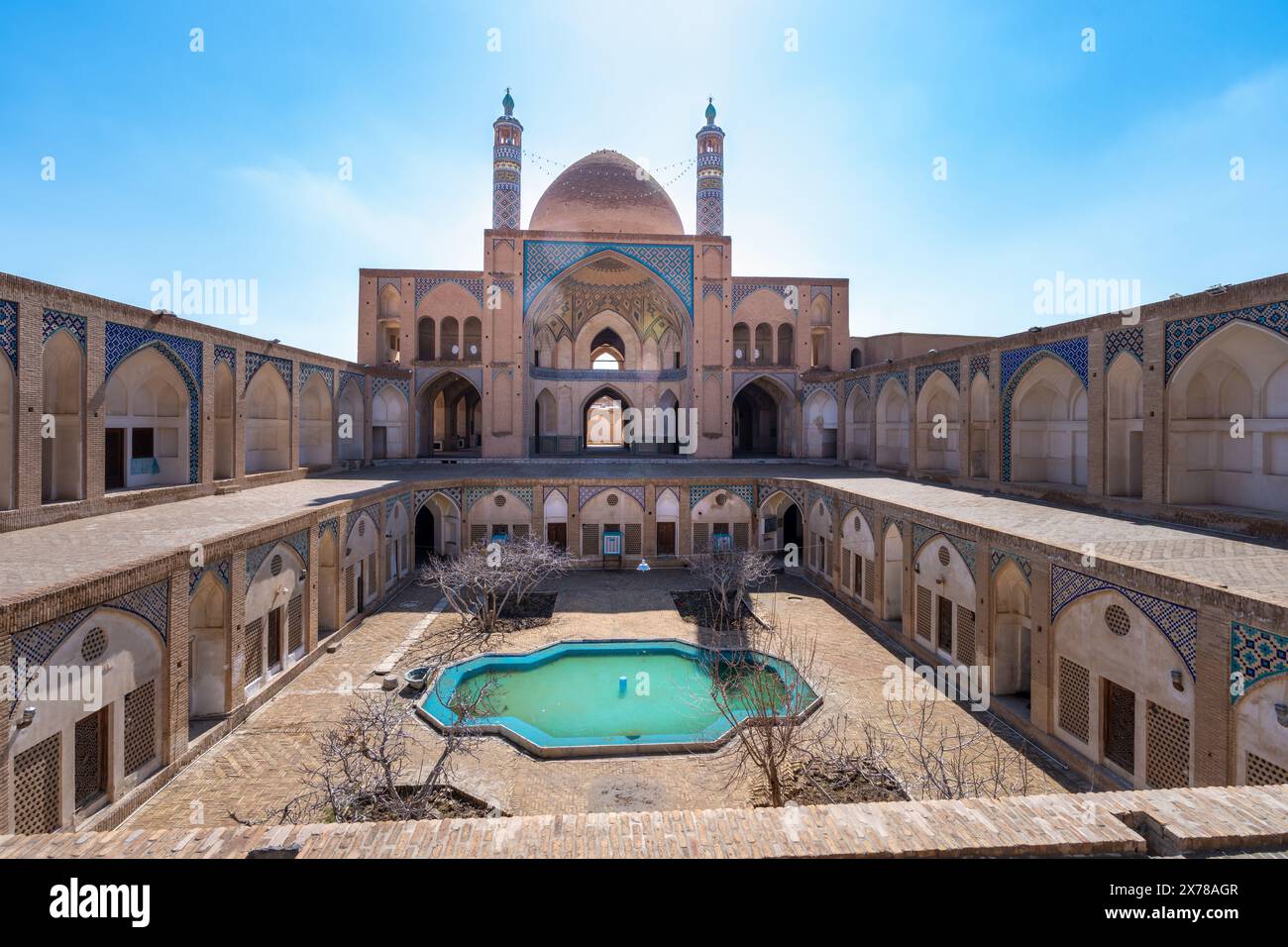 The peaceful courtyard of the Agha Bozog Mosque features a reflecting ...