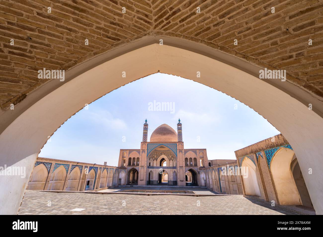Under a clear sky, a stunning arch outlines the Aga Bozog Mosque. The ...