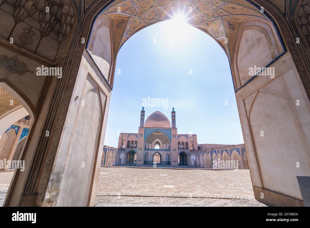 Under a clear sky, a stunning arch outlines the Aga Bozog Mosque. The ...