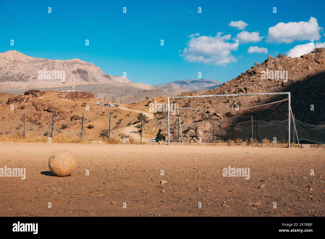 Dusty football pitch in the Omani mountains near Jebel Shams, with a ...