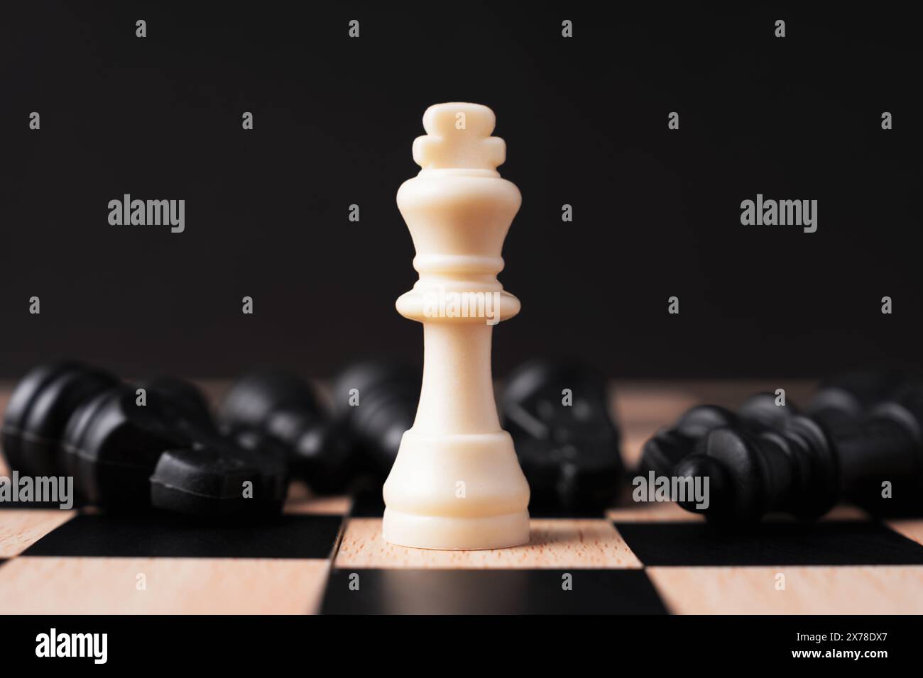 White chess king and fallen black chess black background Stock Photo ...