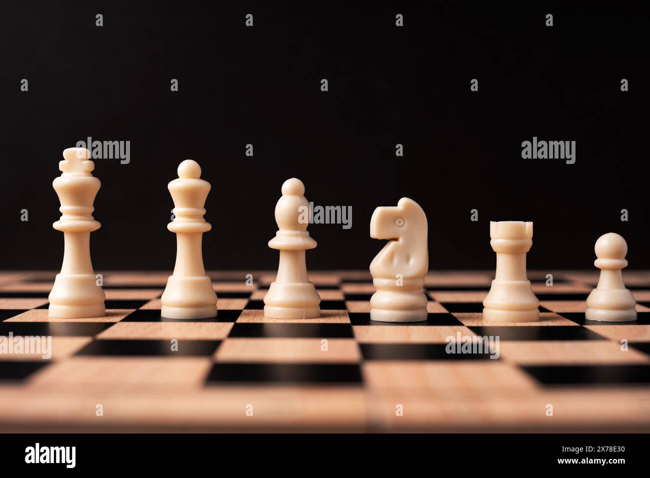 Rows of white chess pieces on black background Stock Photo - Alamy