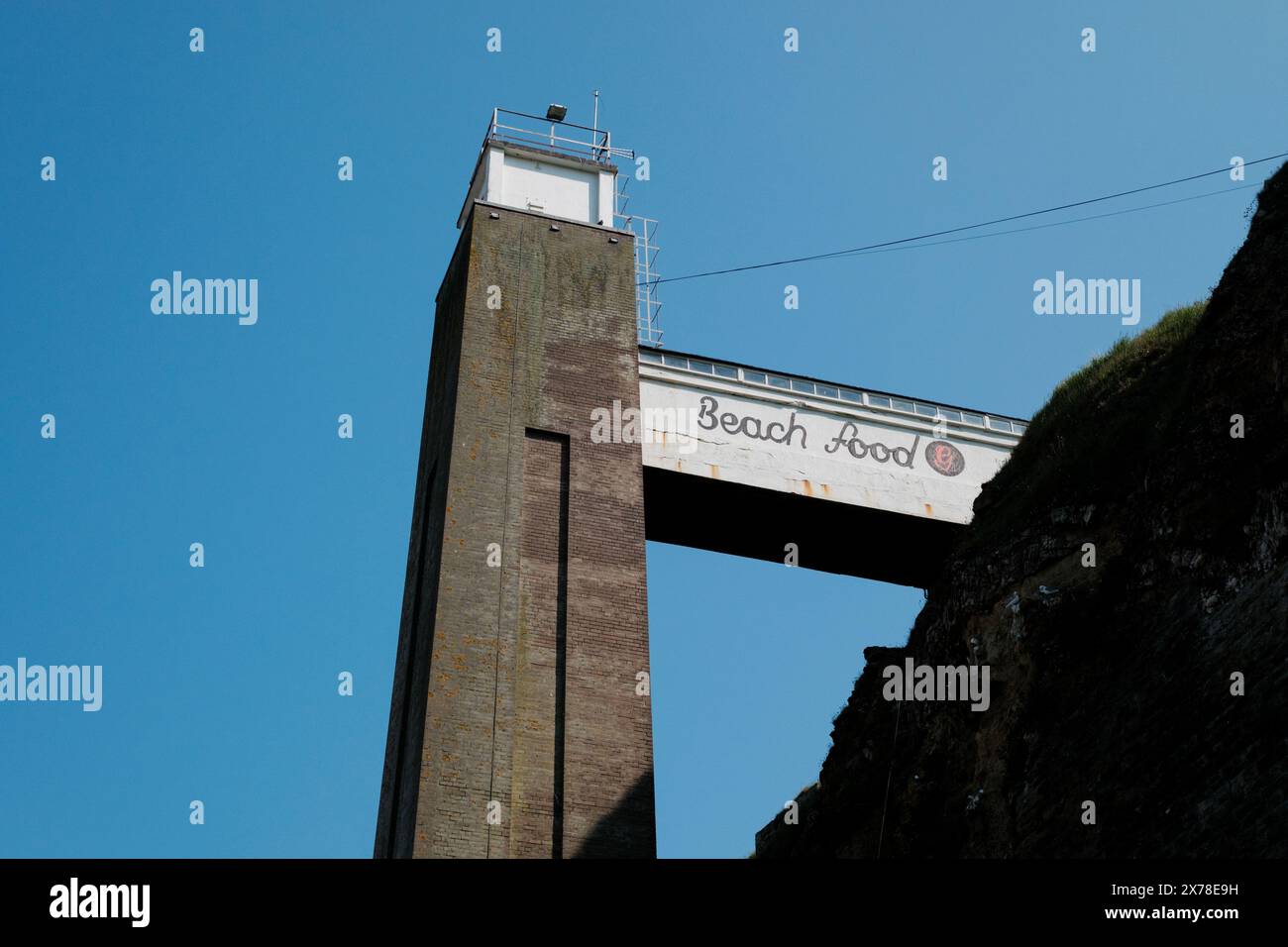 Marsden UK: Marsden Grotto lift tower view from beach with slue sky ...