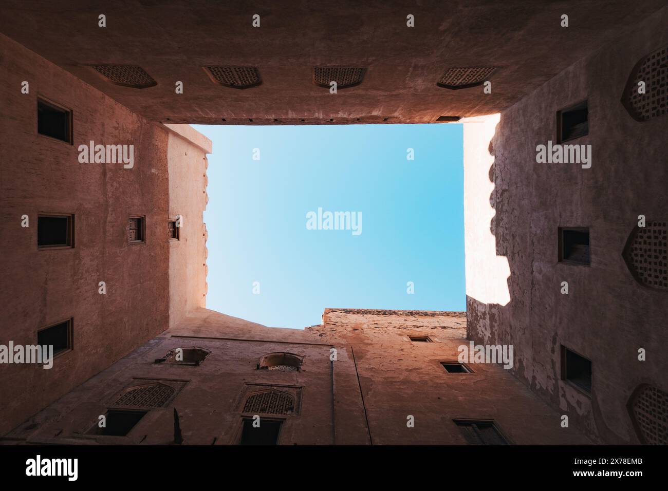 Looking up from inside a courtyard at Jabreen Castle, Oman. Built in ...