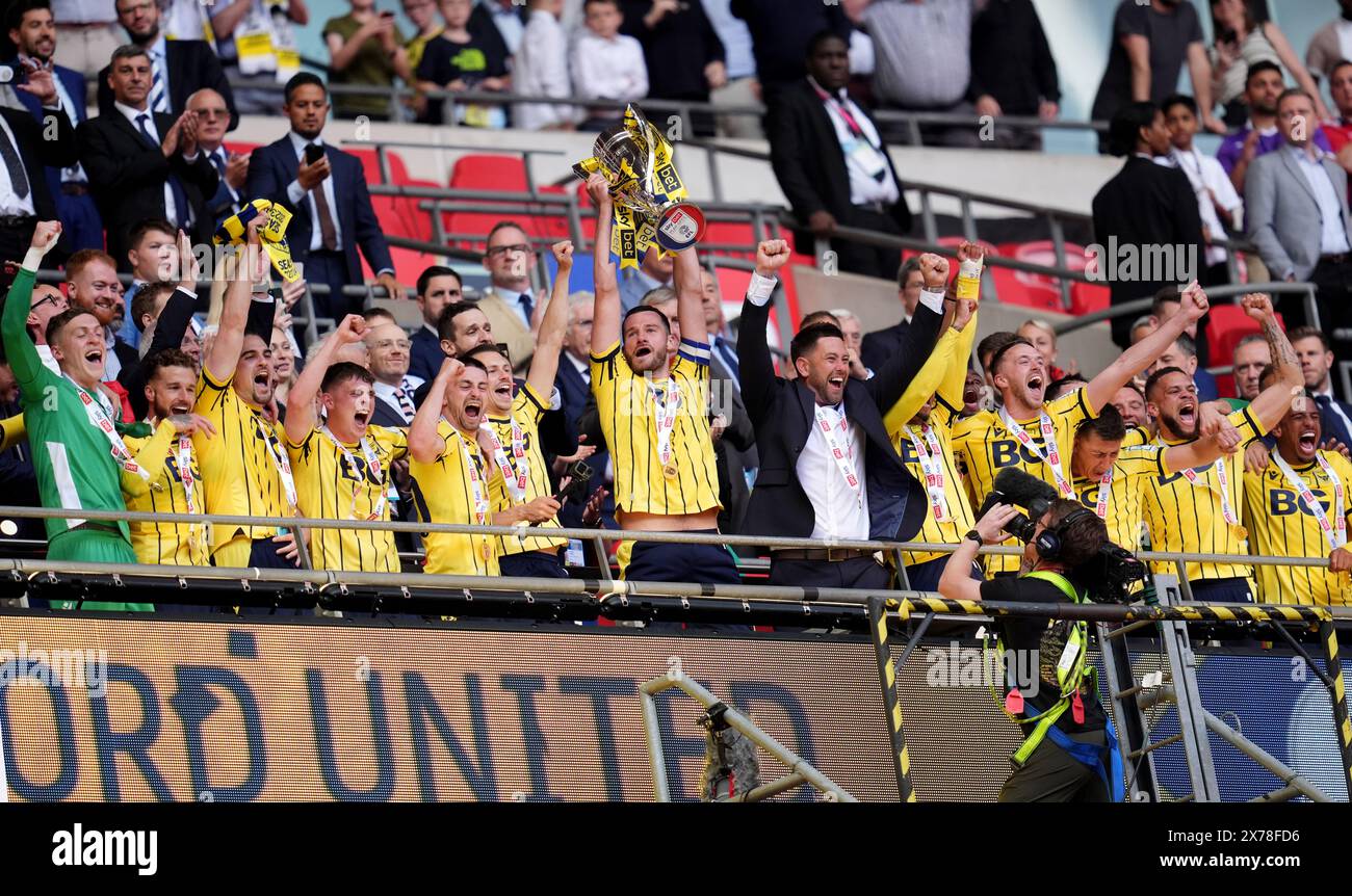 Oxford United's Elliott Moore lifts the trophy after the Sky Bet League ...