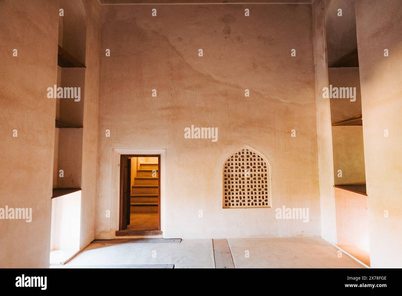 a jail and a doorway in a room with a high ceiling in Jabreen Castle ...