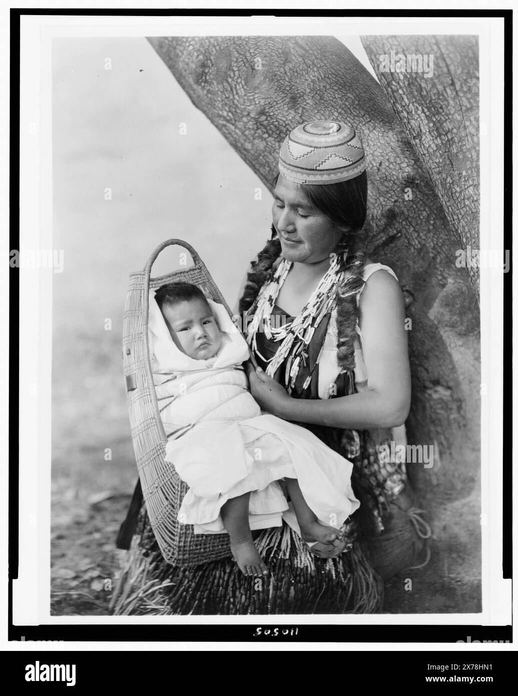 Hupa mother, three-quarter length portrait, seated, facing left ...