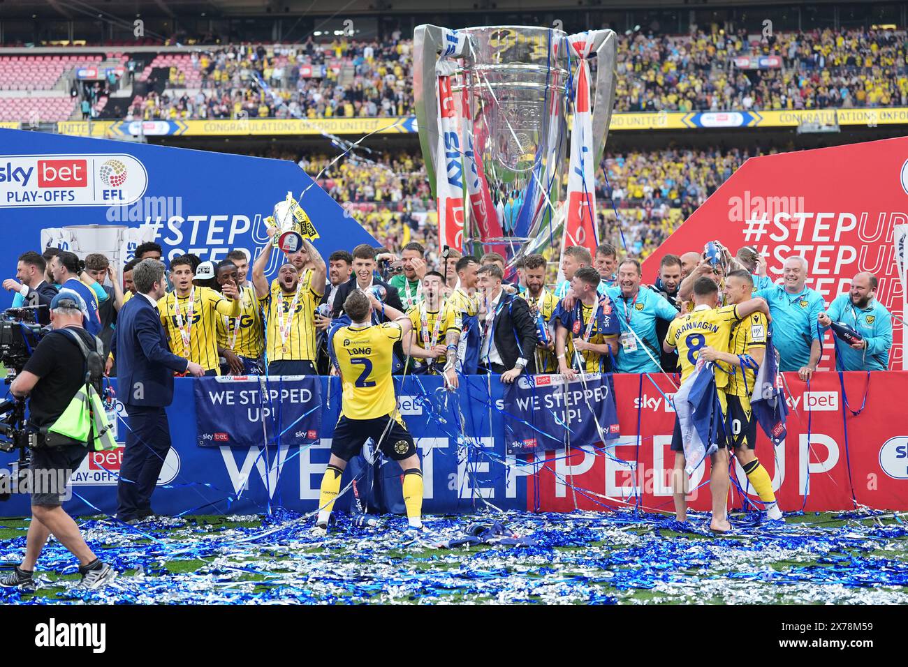 Oxford United lift the trophy during celebrations as their side is ...