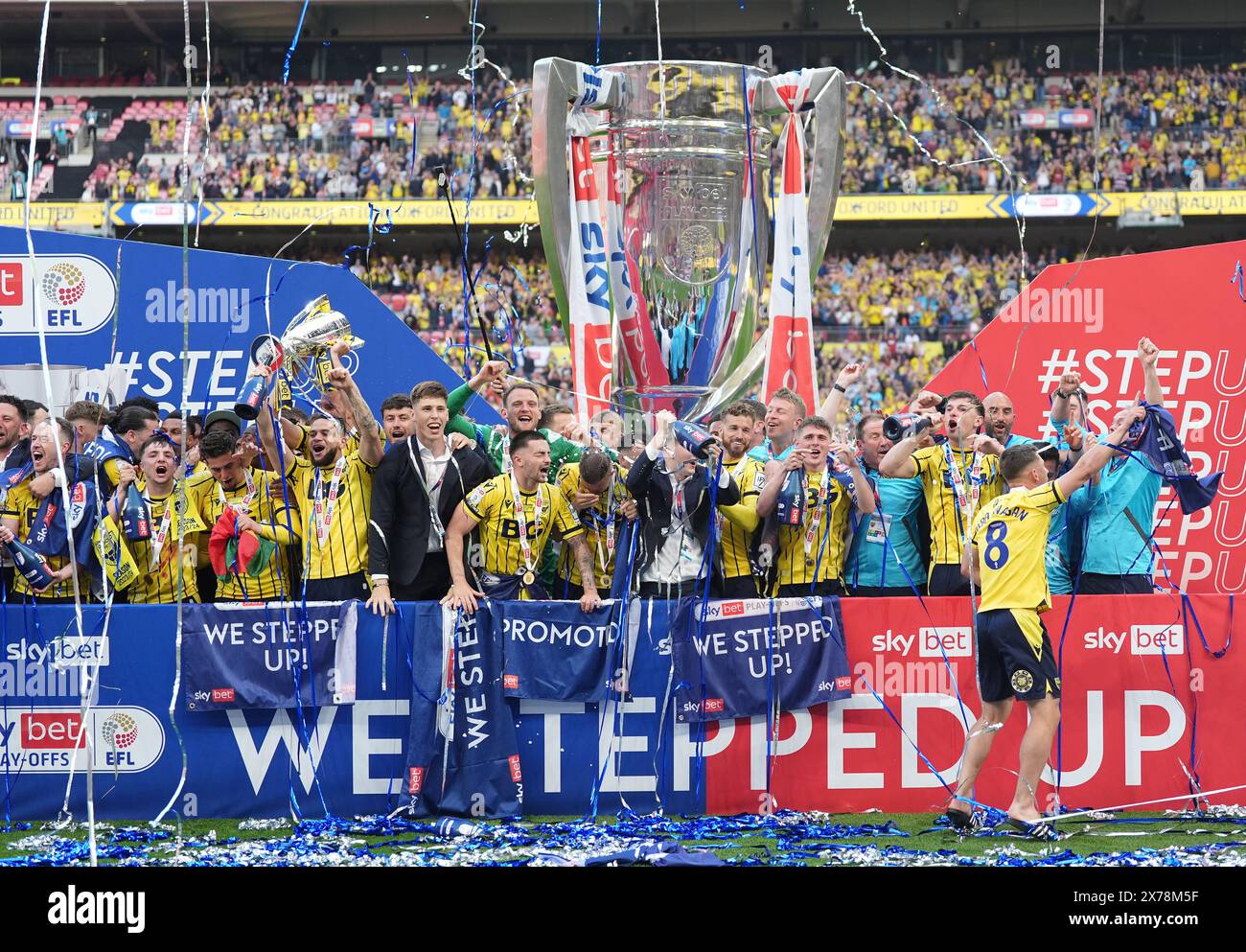 Oxford United lift the trophy during celebrations as their side is ...