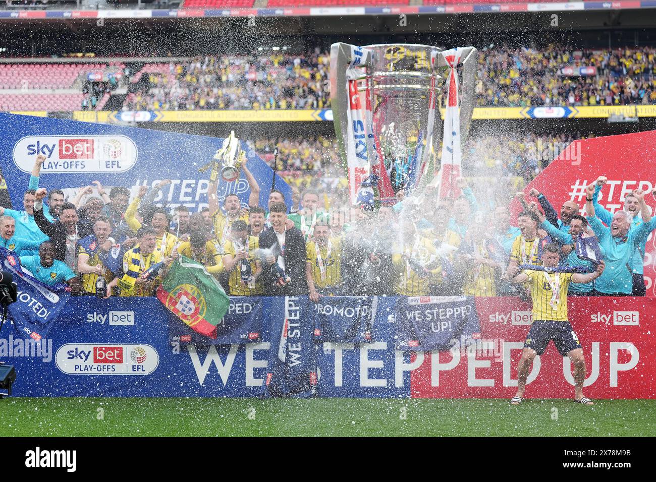 Oxford United lift the trophy during celebrations as their side is ...