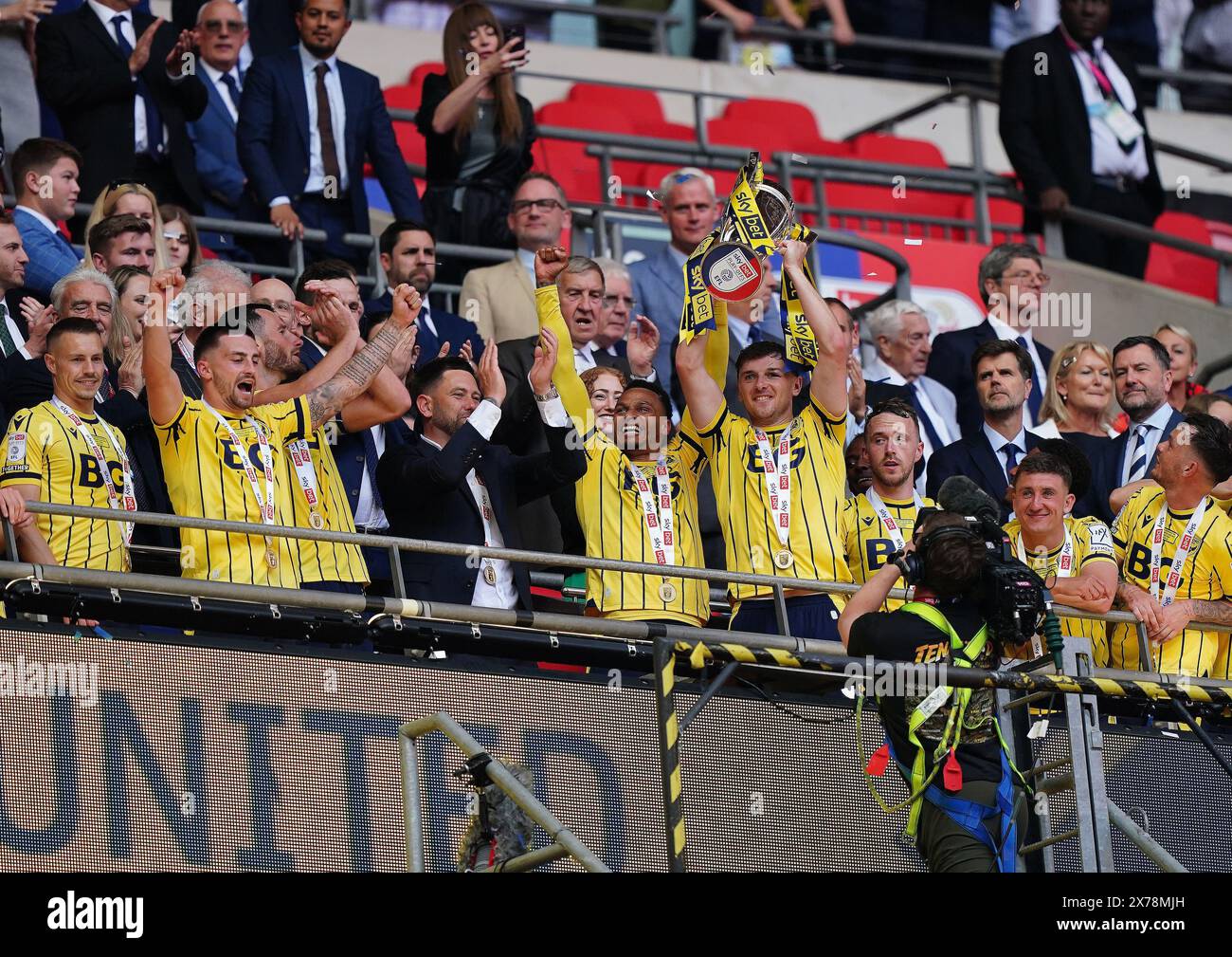 Oxford United lift the trophy during celebrations as their side is ...