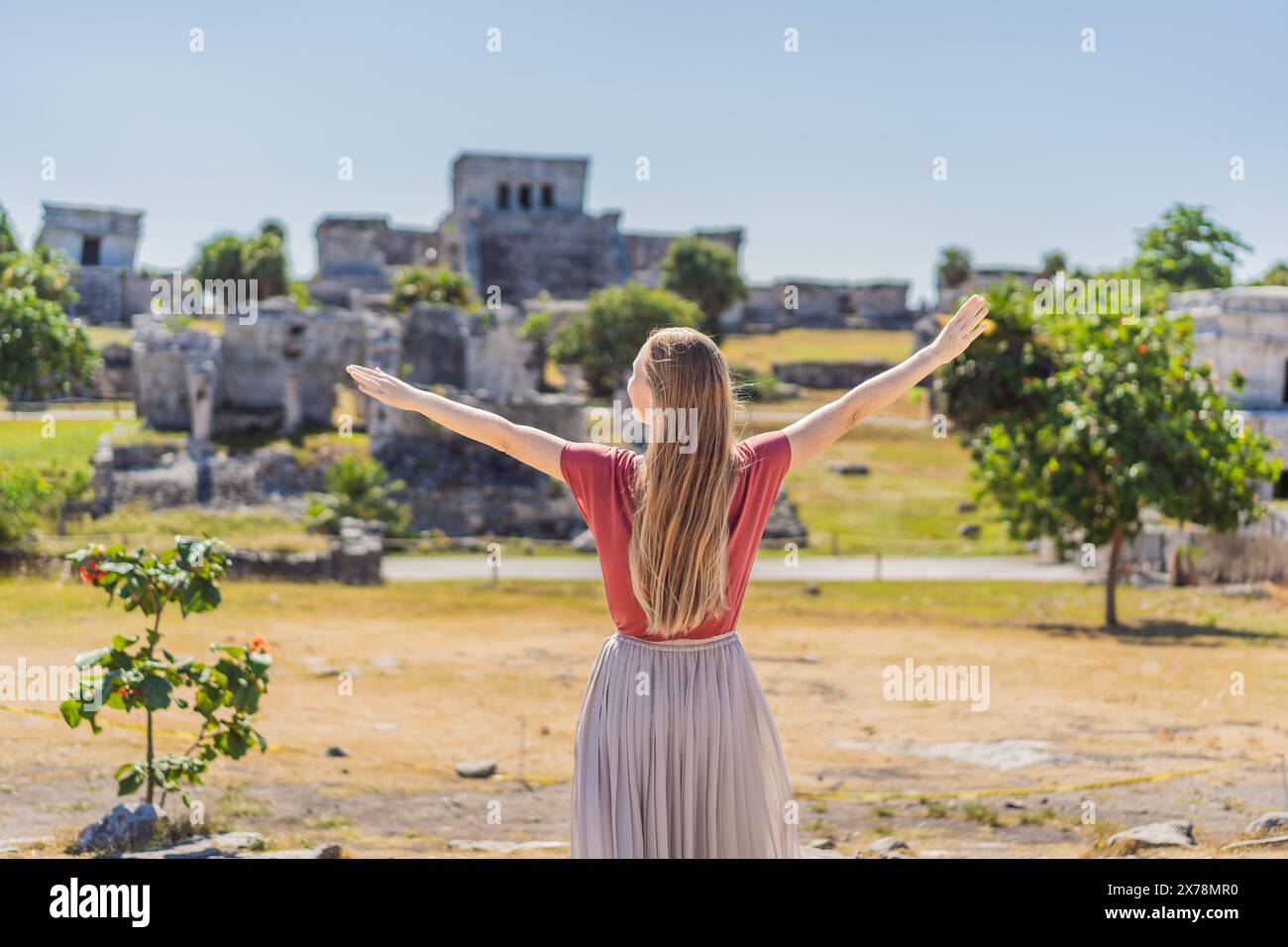 Woman tourist enjoying the view Pre-Columbian Mayan walled city of ...