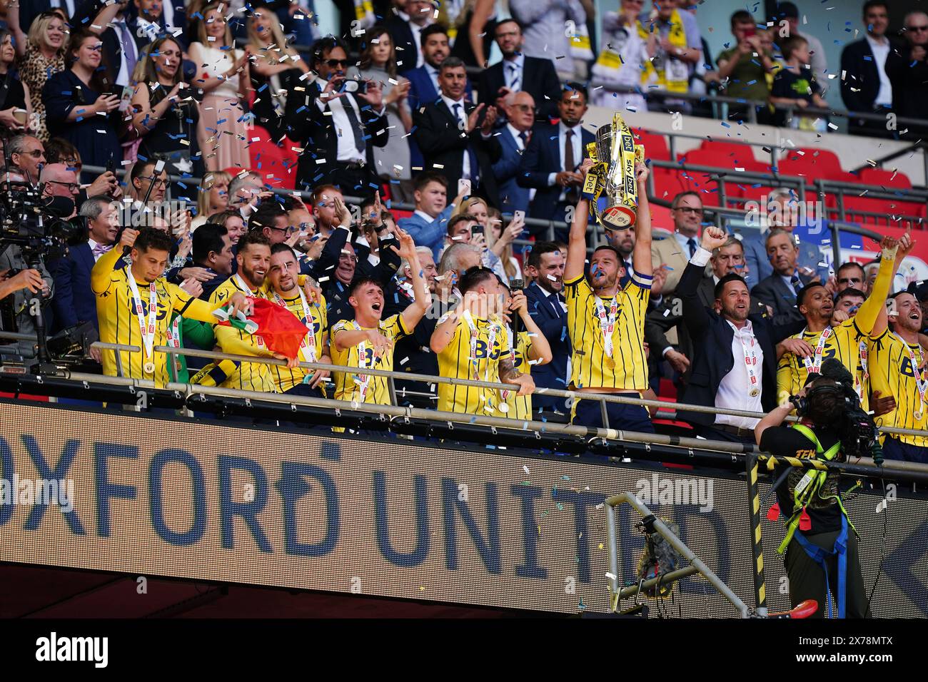 Oxford United lift the trophy during celebrations as their side is ...
