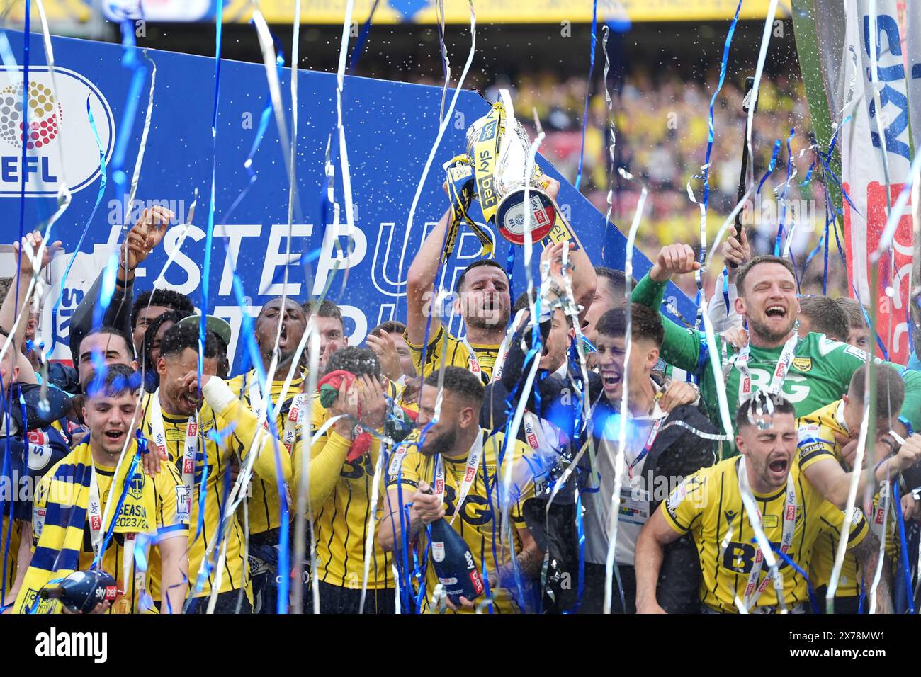 Oxford United lift the trophy during celebrations as their side is ...