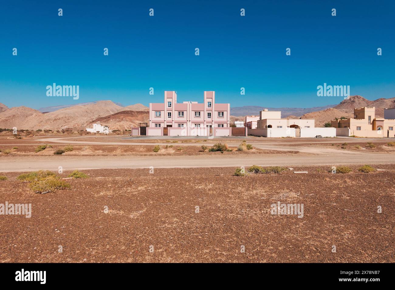 a pink and rectangular regional modernist style home in rural Oman ...