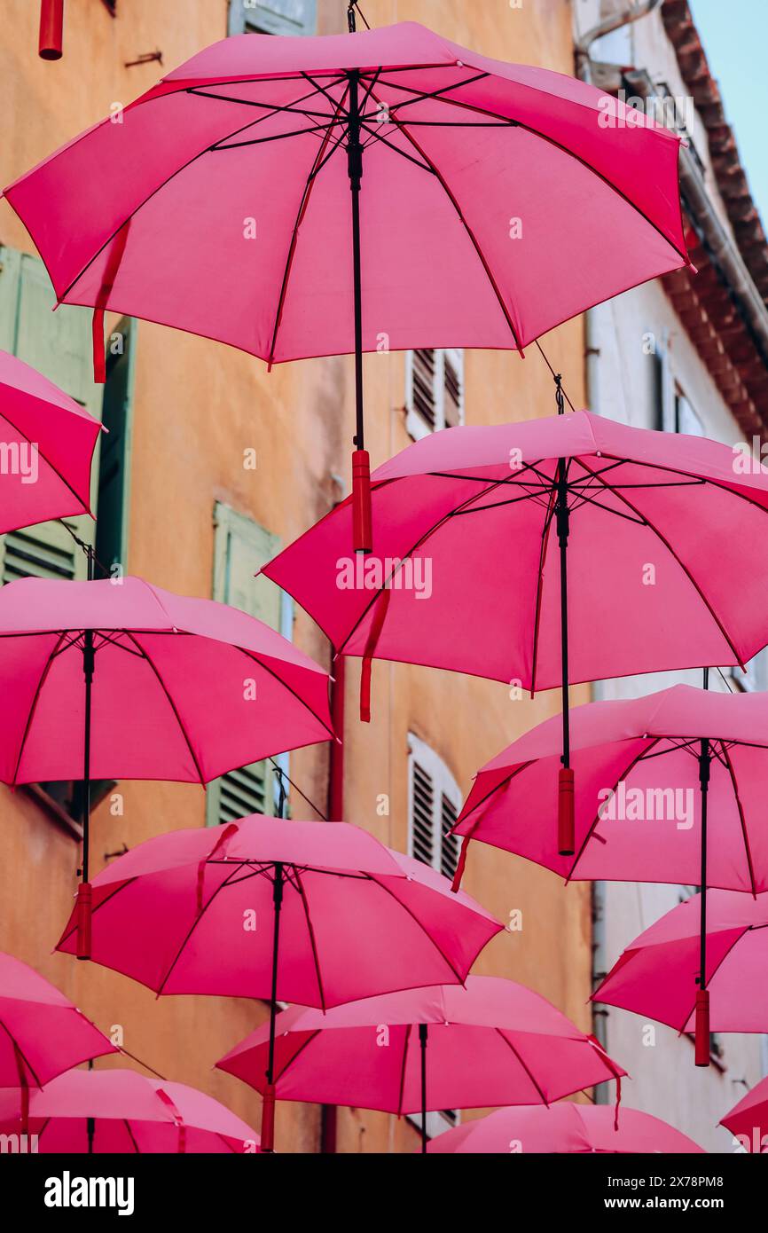 Famous pink umbrellas decorating the central streets of Grasse Stock ...