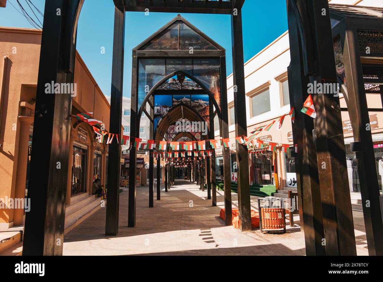 a traditional souq in the city of Sur, Oman, during midday sun. A ...