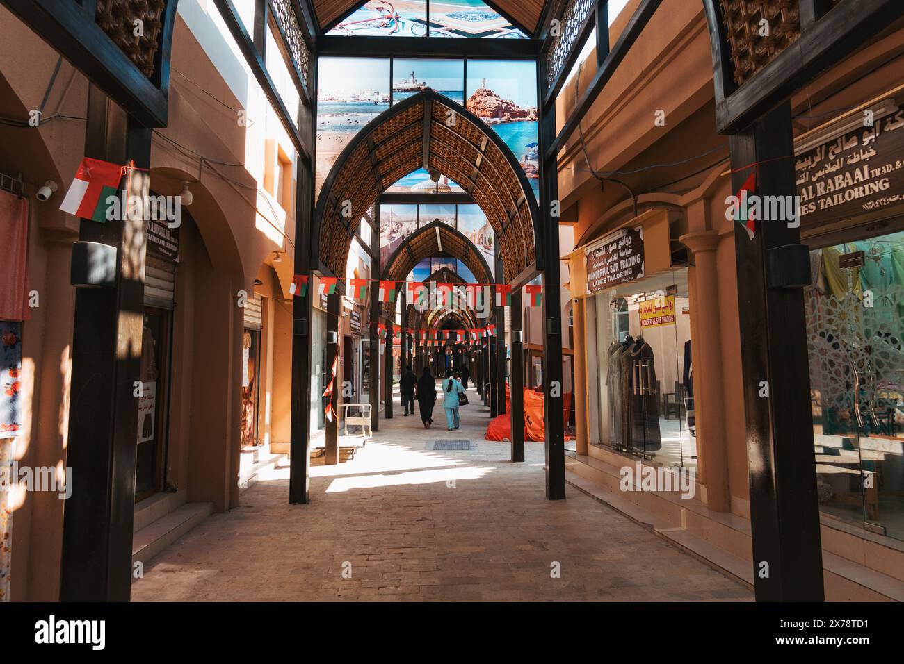 a traditional souq in the city of Sur, Oman, during midday sun. A ...