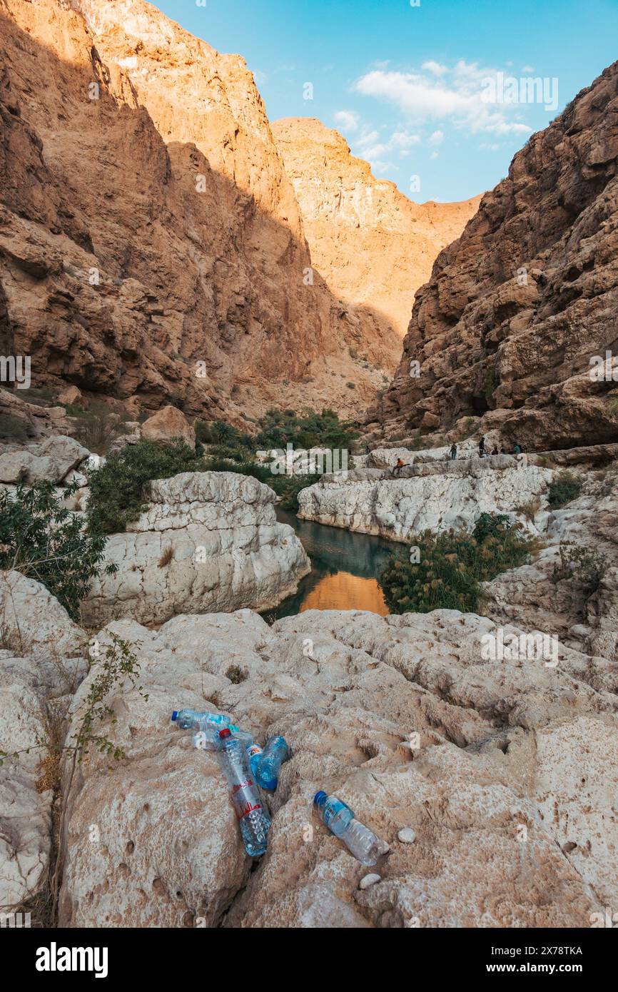 Plastic bottles litter the rocky landscape of Wadi Shab, Oman ...