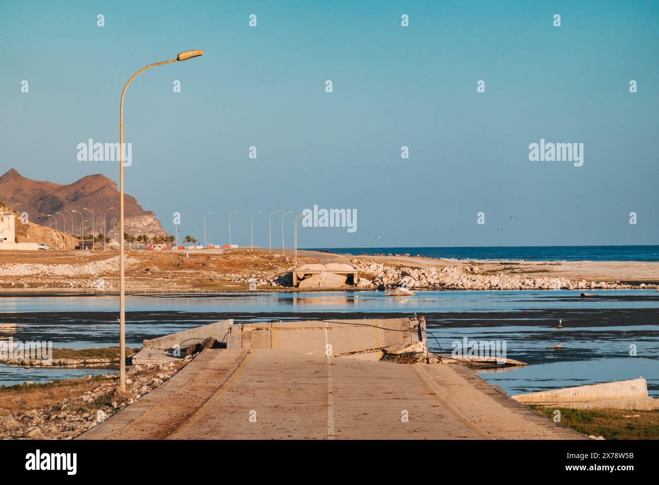 Collapsed bridge at Al Mughsail Beach in Oman, with broken road ...