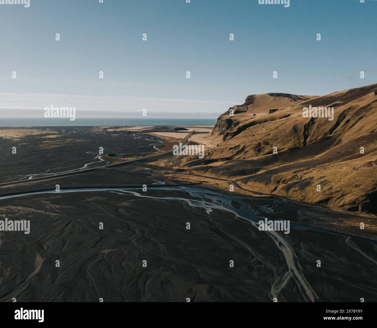 Aerial view of rugged landscape and river in South Iceland under a ...
