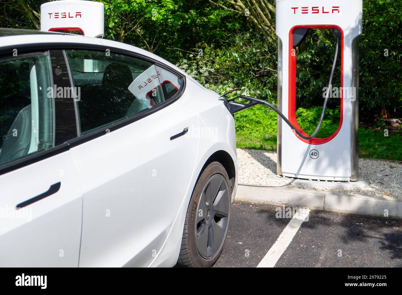 Tesla car recharging at motorway service station, England, UK Stock ...
