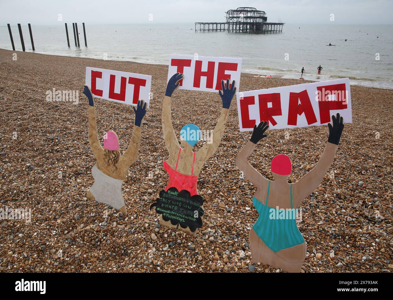 Brighton, England, UK. 18th May, 2024. Three wooden figures hold signs ...