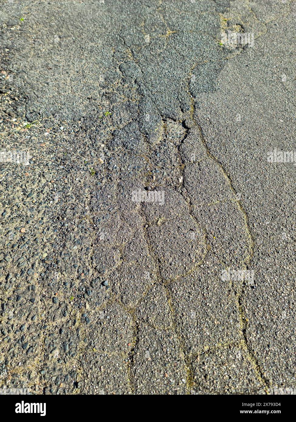 View of road asphalt with many cracks and potholes in urgent need of ...