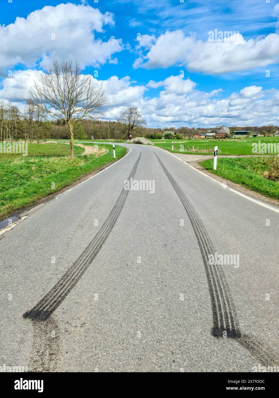 View of two black tire tracks made of burnt rubber from a car driving ...