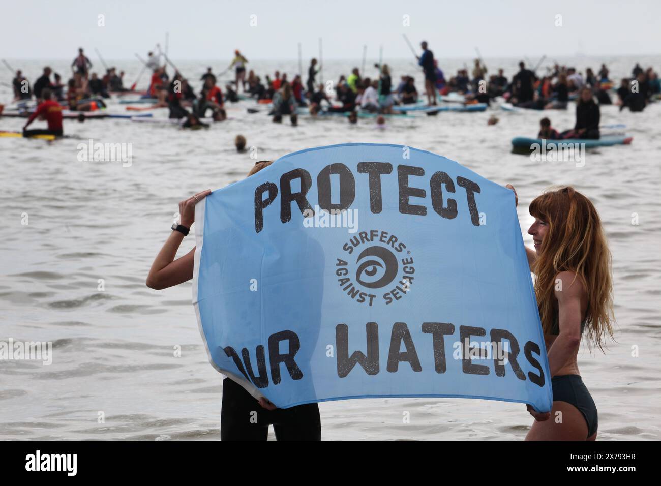 Brighton, England, UK. 18th May, 2024. Protesters hold a banner saying ...