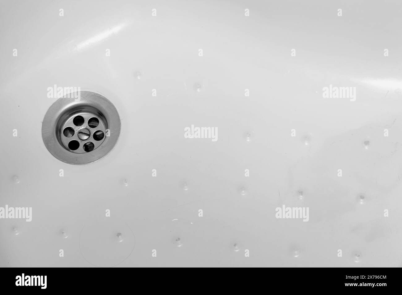 Detail of a ceramic white sink in a modern bathroom with chrome plated ...