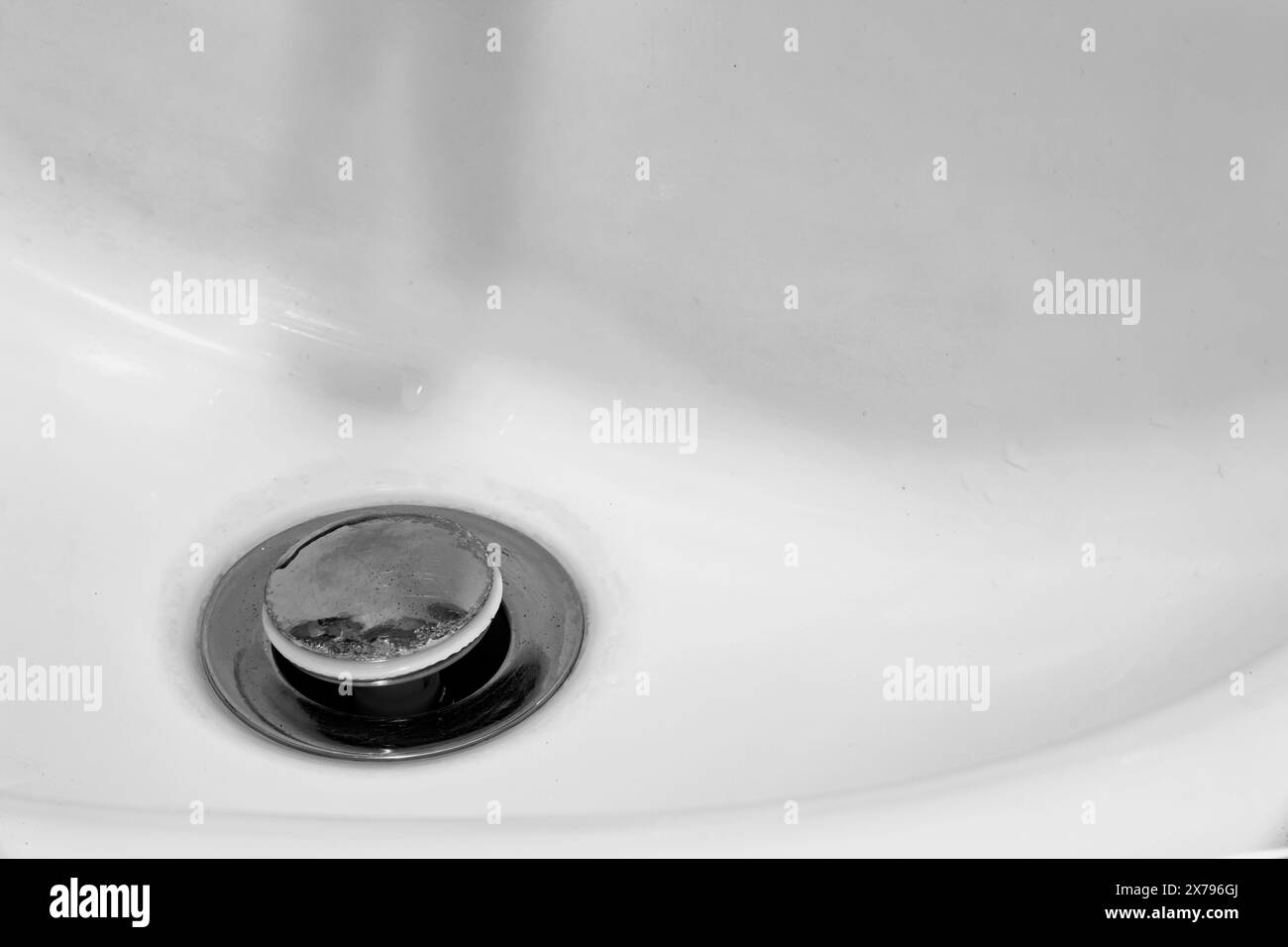 Detail of a ceramic white sink in a modern bathroom with chrome plated ...