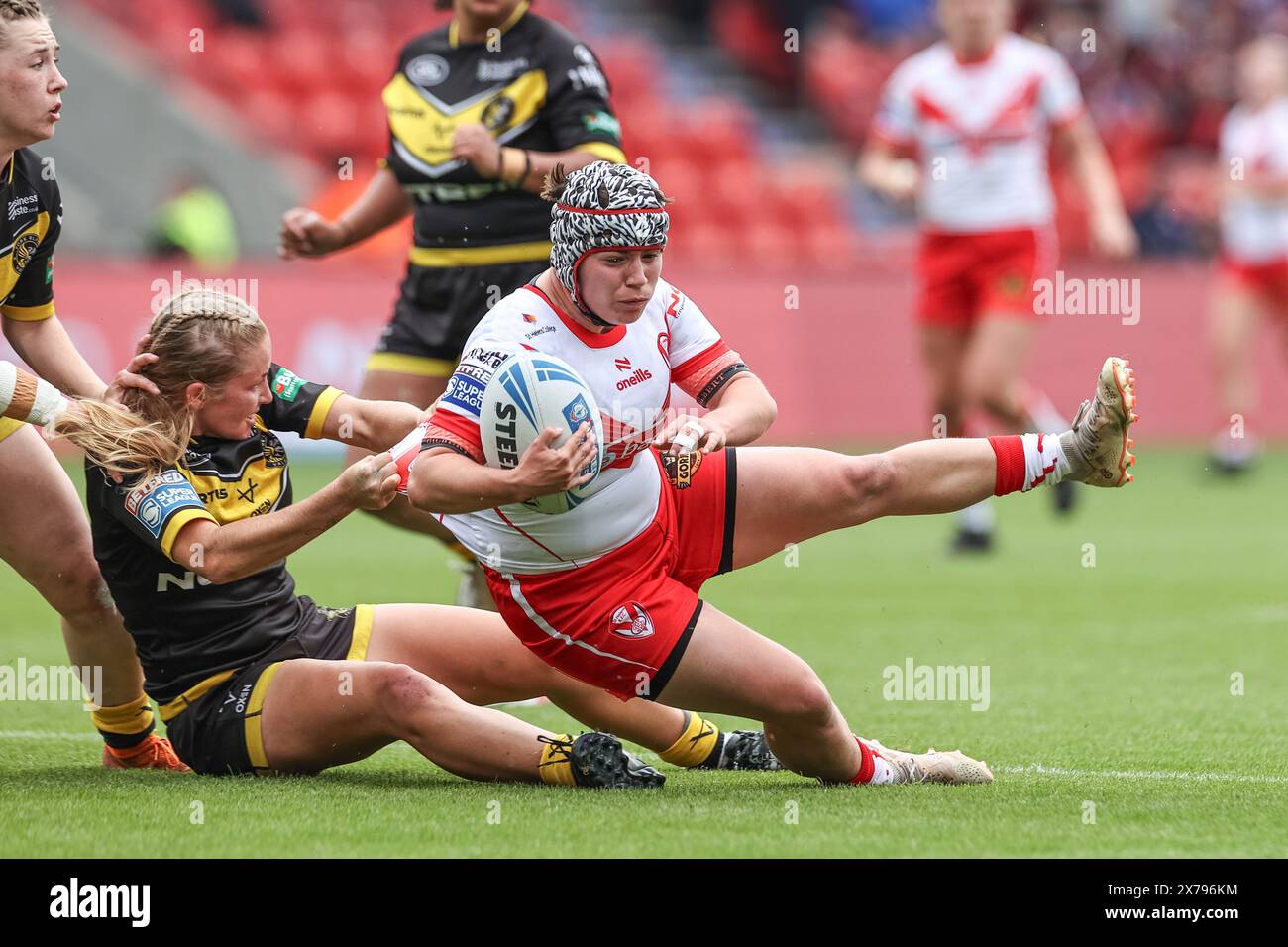 Katie Mottershead of St Helens is tackled by Alex Stimpson of York RLFC ...